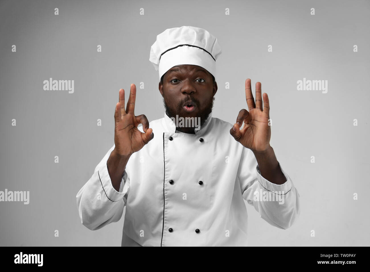 African American chef in uniform on light background Stock Photo - Alamy