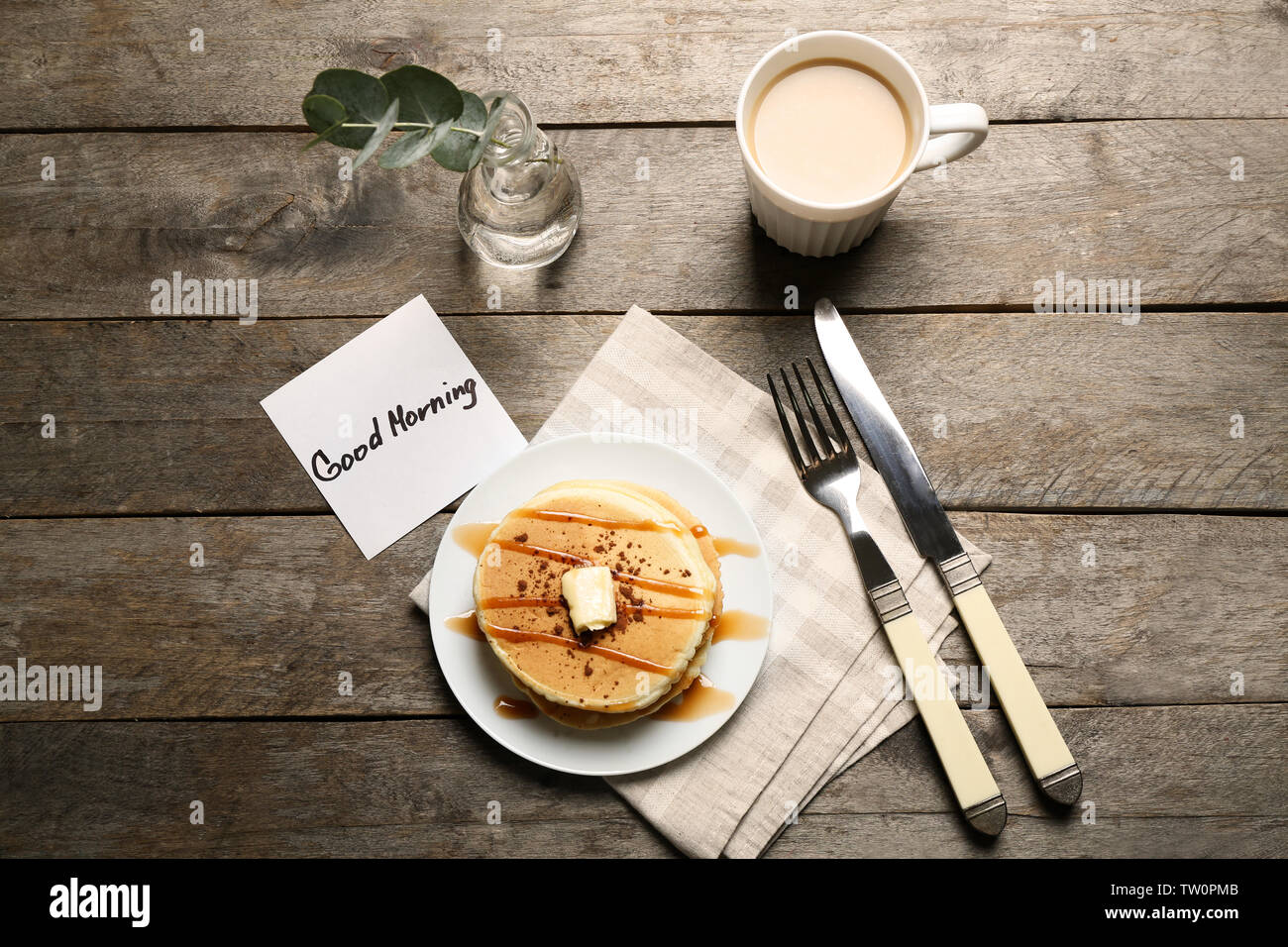 Delicious breakfast and GOOD MORNING greeting note on wooden table, top ...