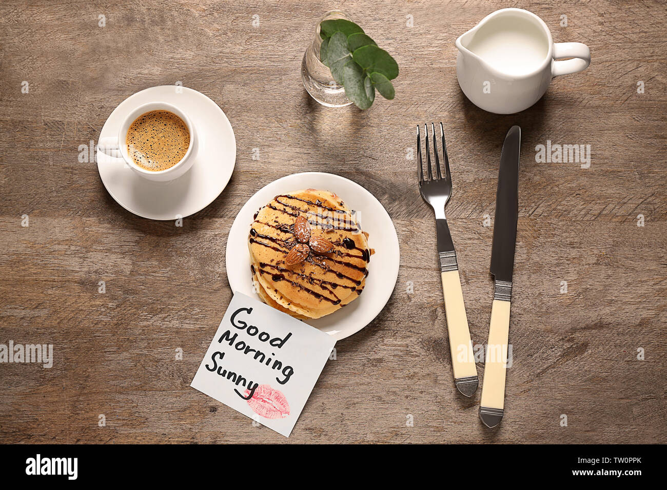 Delicious breakfast and GOOD MORNING greeting note on wooden table, top ...