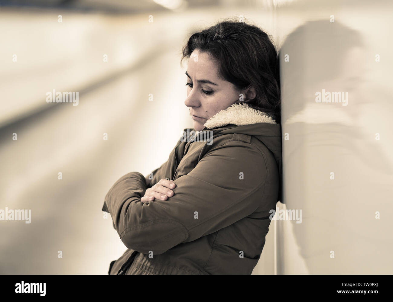 Hopeless and exhausted woman suffering depression and anxiety in subway ...