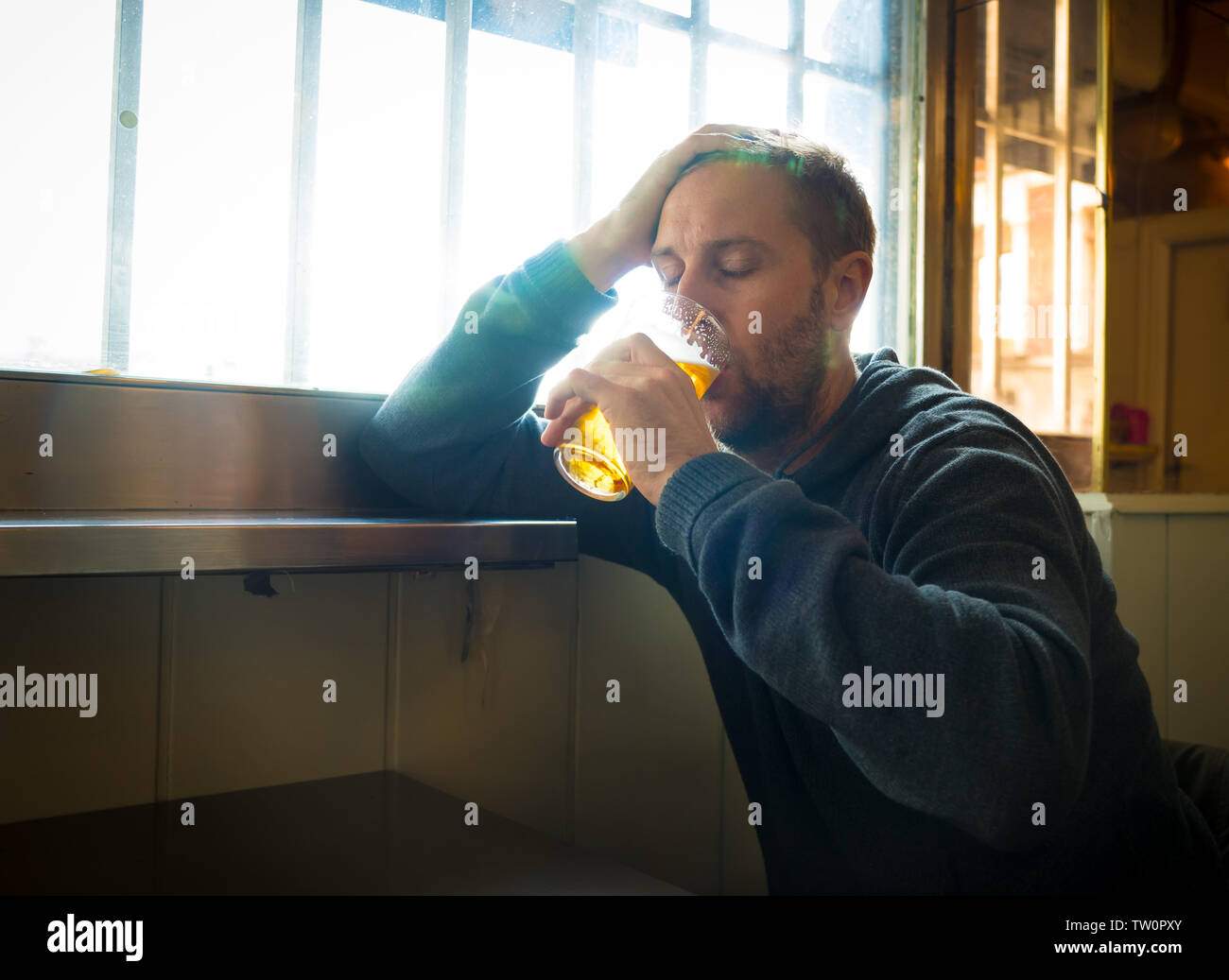 Unhappy man in pub portrait hi-res stock photography and images - Alamy