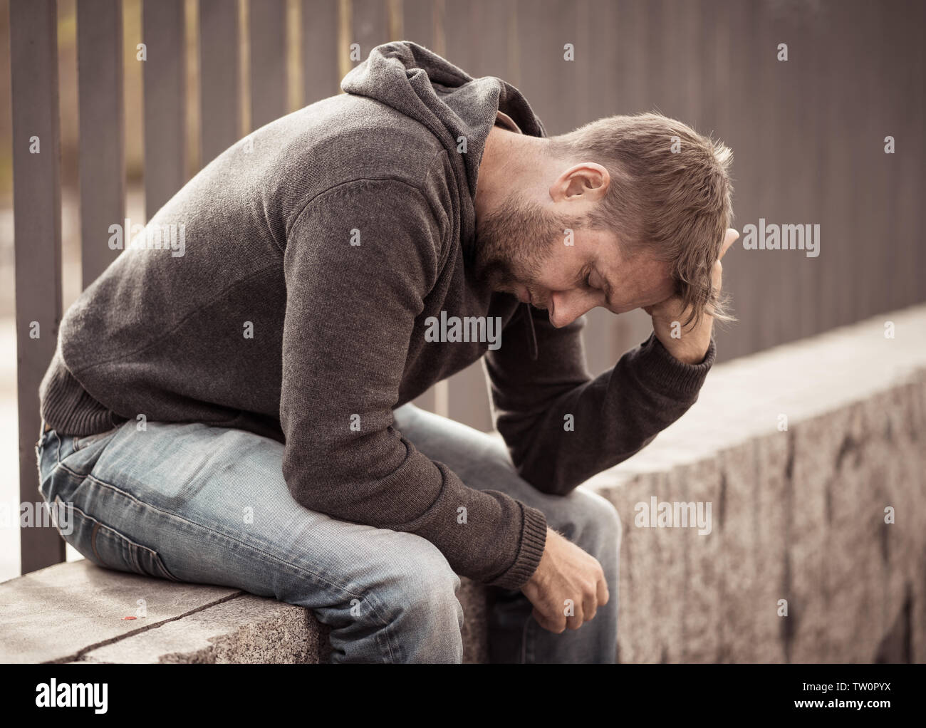 Young attractive man suffering from depression stress sitting alone and ...