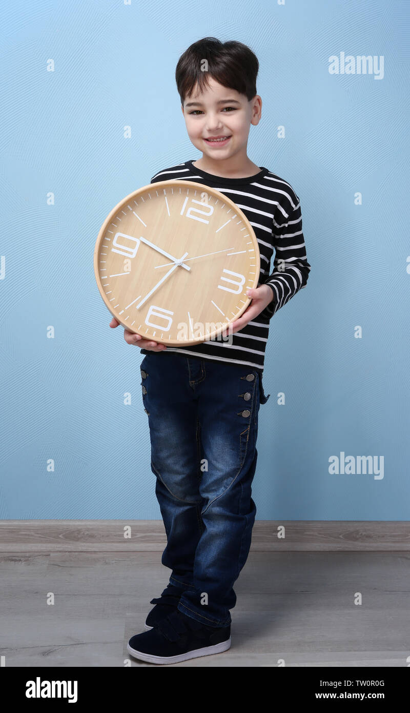 Cute little boy with big clock at home Stock Photo - Alamy