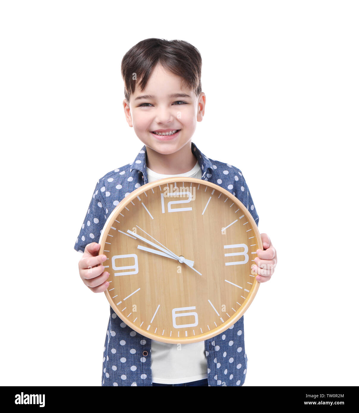 Cute little boy with big clock on white background Stock Photo - Alamy
