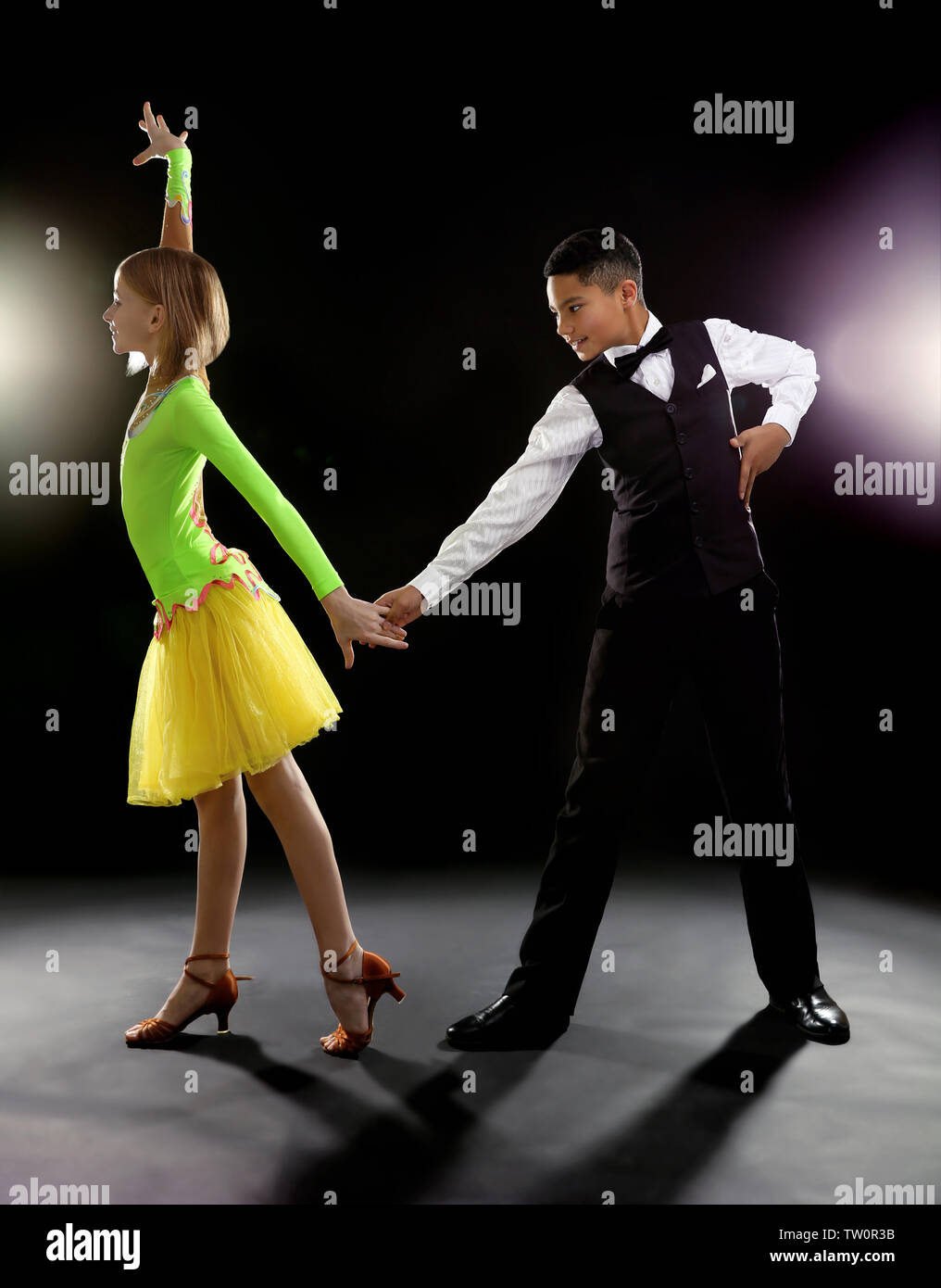 Cute dancing children on dark background Stock Photo - Alamy