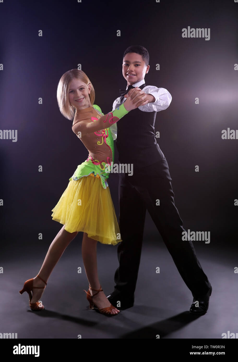 Cute dancing children on dark background Stock Photo - Alamy