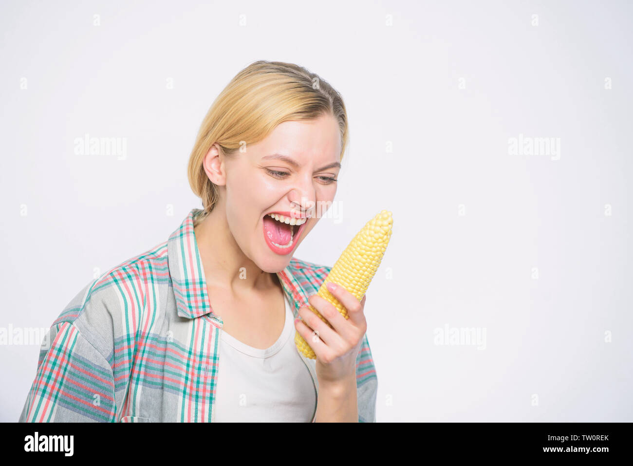 woman eating a delicious corncob. Happy woman eating corn. vegetable ...