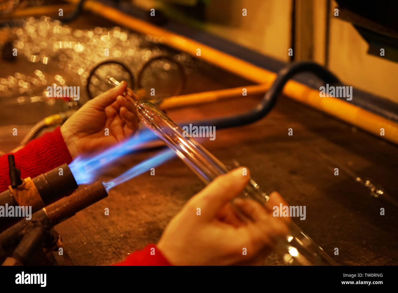 Glassblower heating glass for shaping Christmas ornament Stock Photo ...