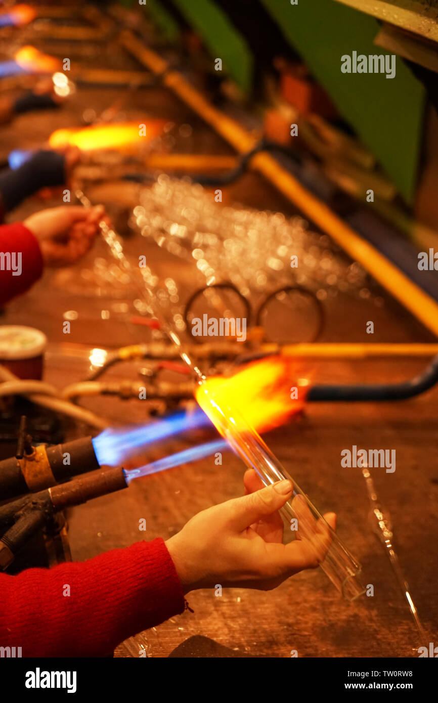 Glassblower heating glass for shaping Christmas ornament Stock Photo ...