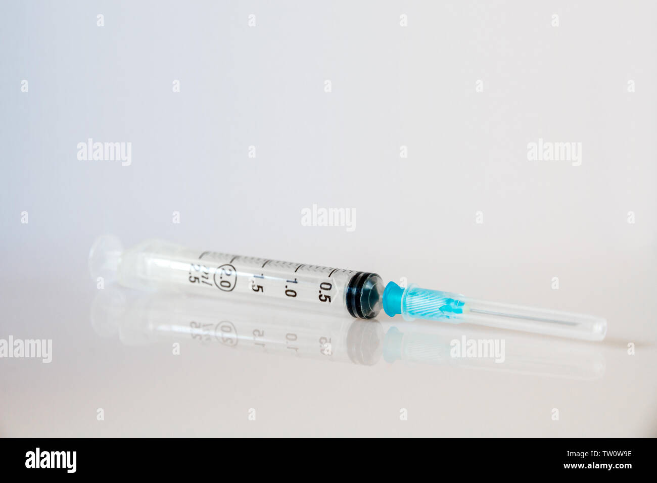 Injection syringe on a clean grey background Stock Photo - Alamy