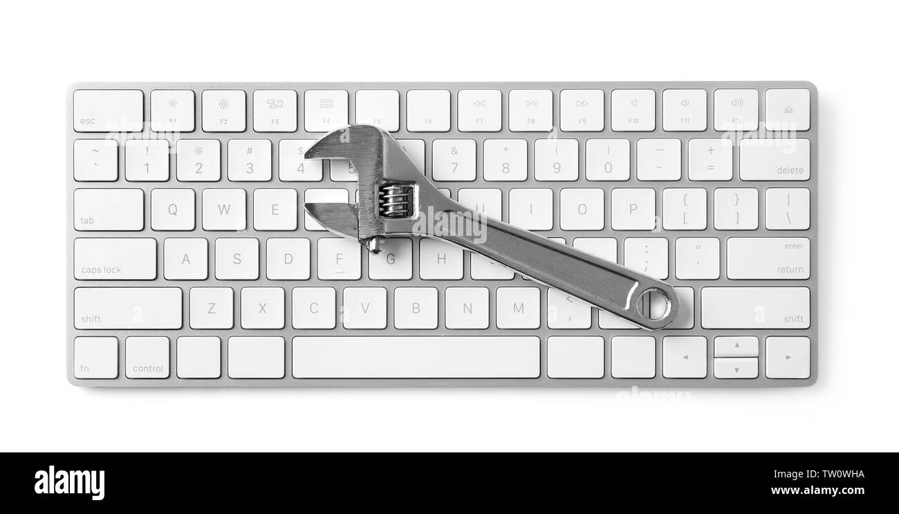 Modern wireless keyboard and adjustable wrench on white background ...