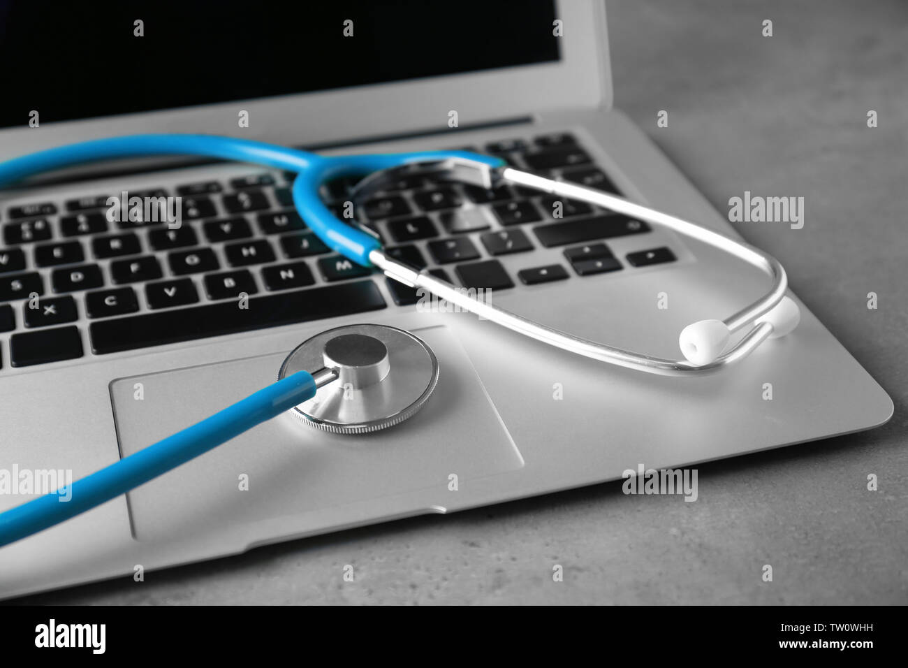 Modern laptop and stethoscope on table Stock Photo - Alamy