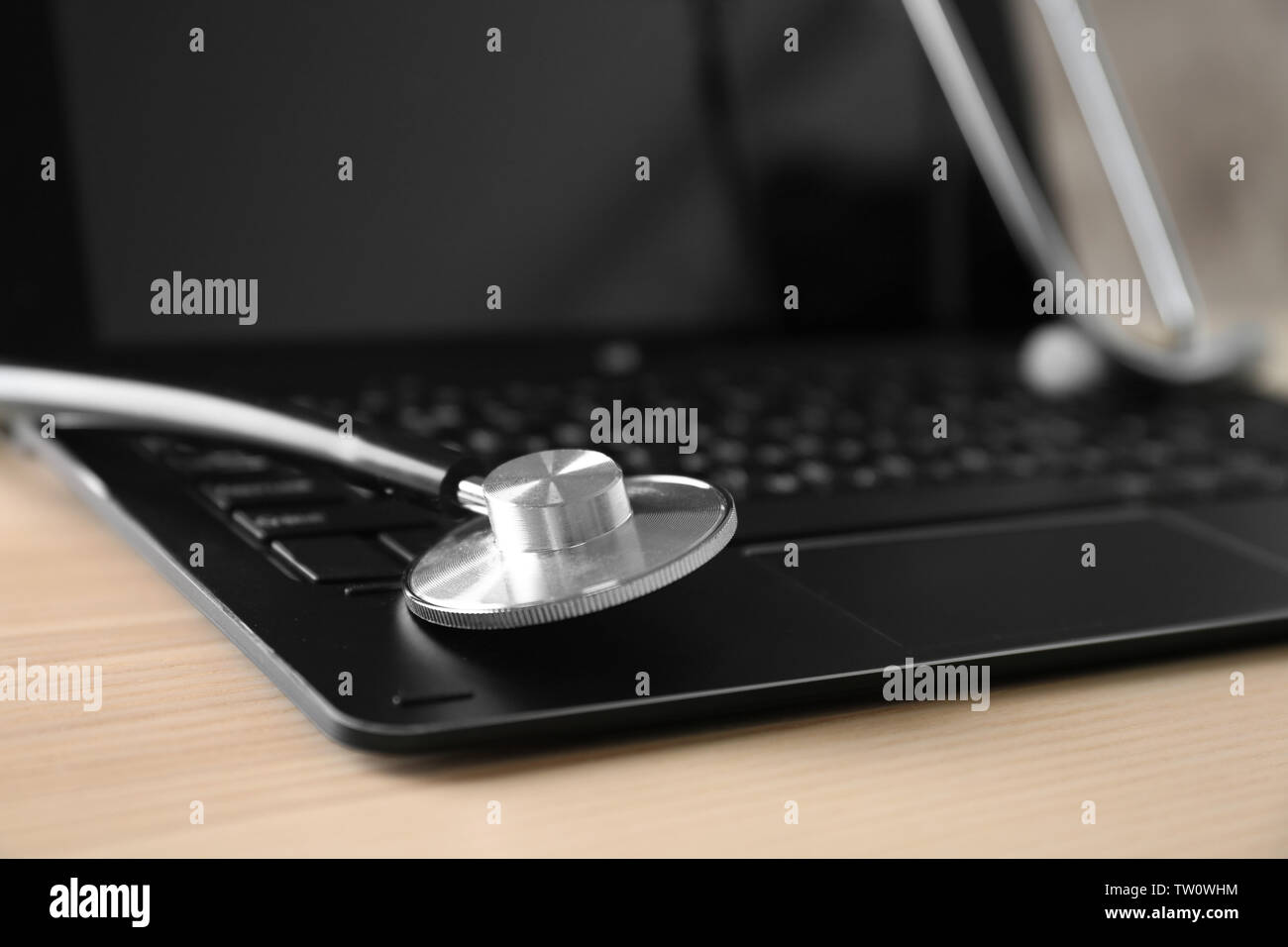 Modern laptop and stethoscope on table Stock Photo - Alamy