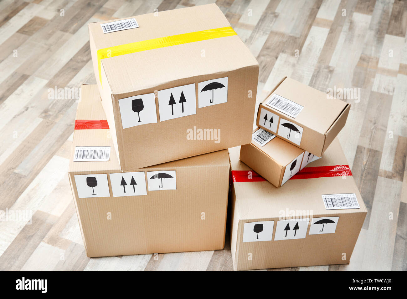 Cardboard boxes on wooden floor Stock Photo - Alamy