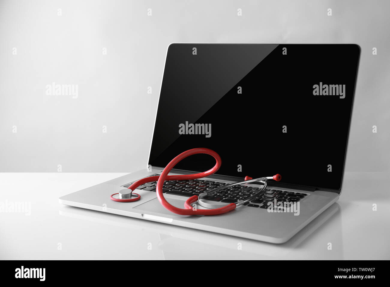 Modern laptop and stethoscope on white background Stock Photo - Alamy