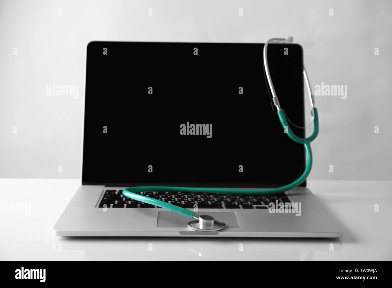 Modern laptop and stethoscope on white background Stock Photo - Alamy