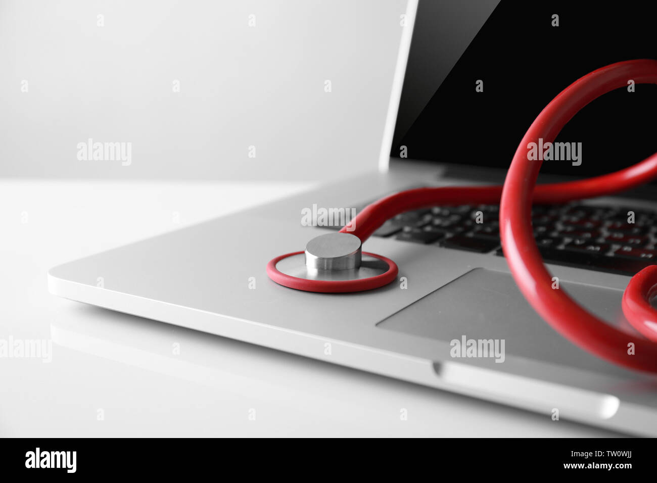 Modern laptop and stethoscope on white background Stock Photo - Alamy