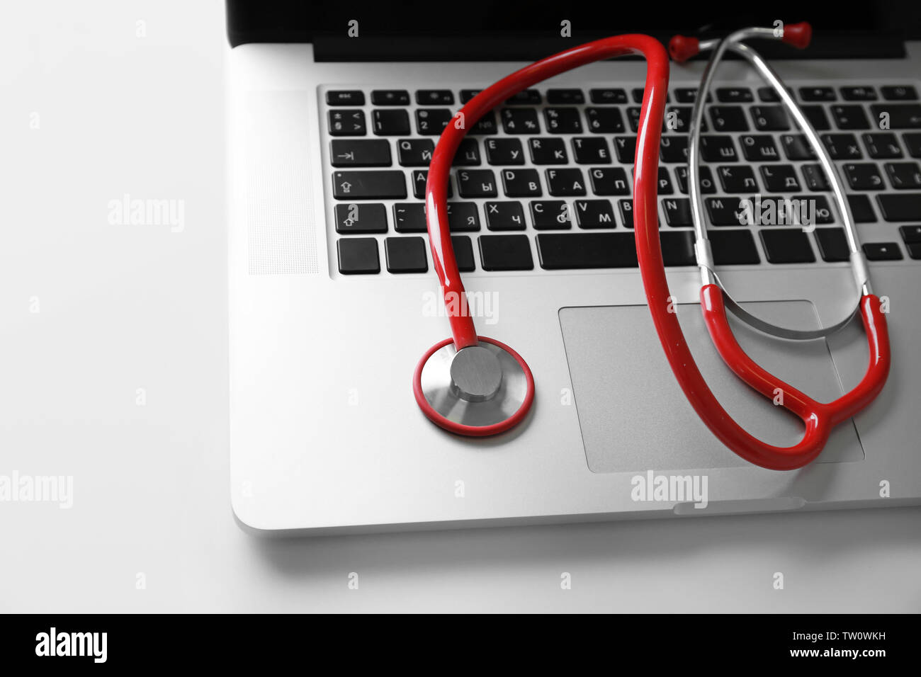 Modern laptop and stethoscope on white background Stock Photo - Alamy
