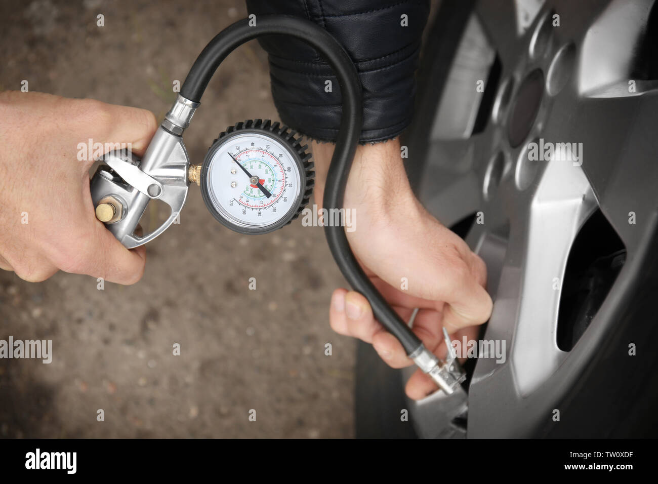 Mechanic checking tire pressure hi-res stock photography and images - Alamy
