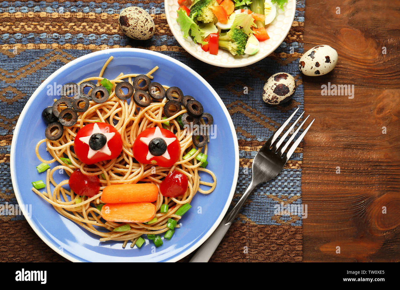 Plate with creative pasta for children on wooden background Stock Photo ...