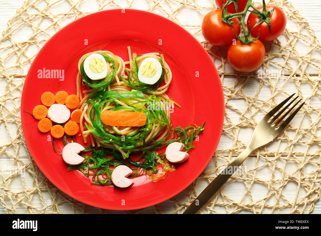 Plate with creative pasta for children on wicker mat Stock Photo - Alamy