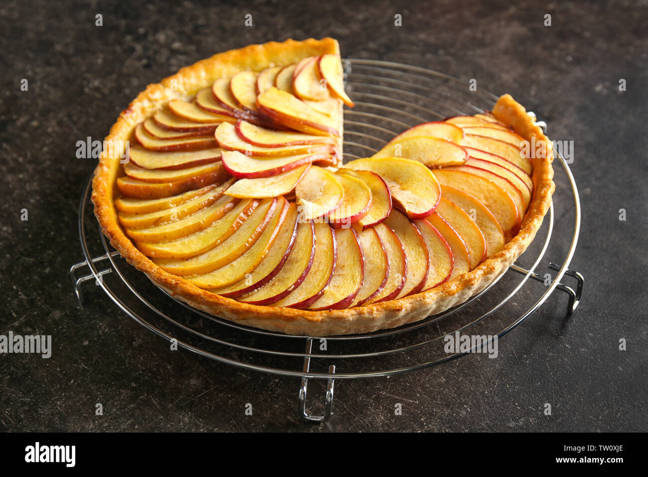 Metal stand with homemade apple pie on table Stock Photo - Alamy