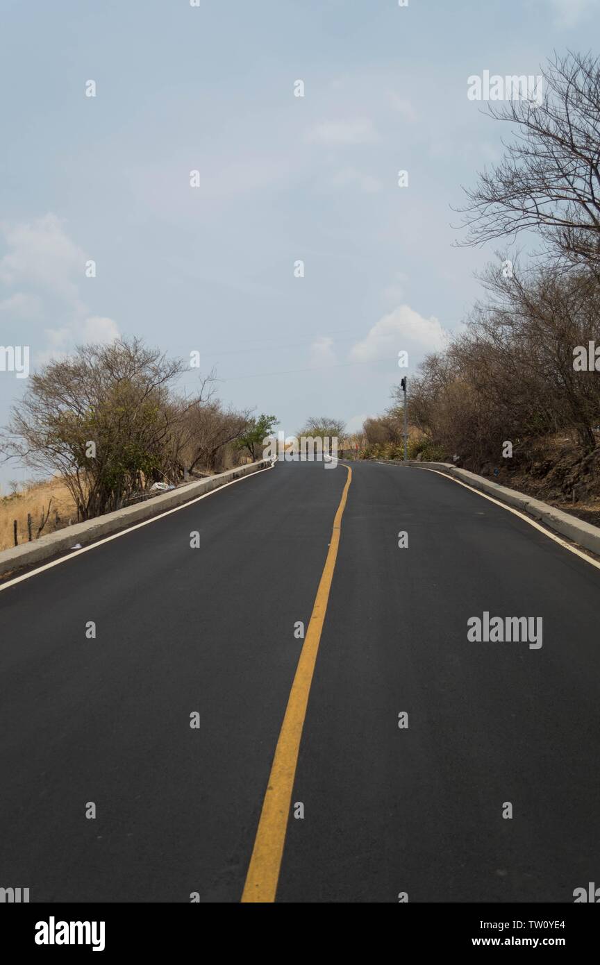 Cement road in near a desert Stock Photo - Alamy