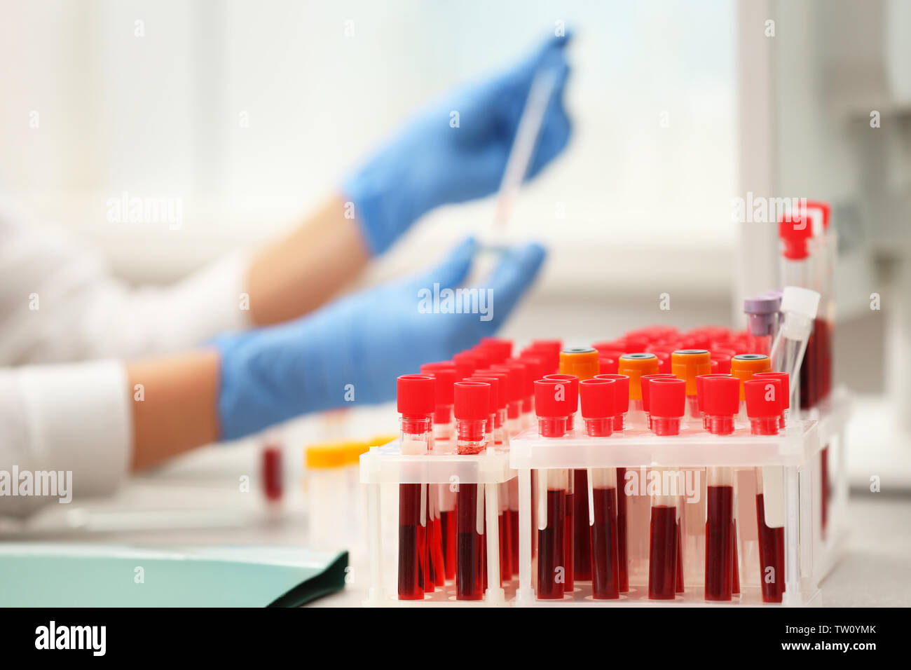 Test tubes with blood on table in laboratory Stock Photo - Alamy