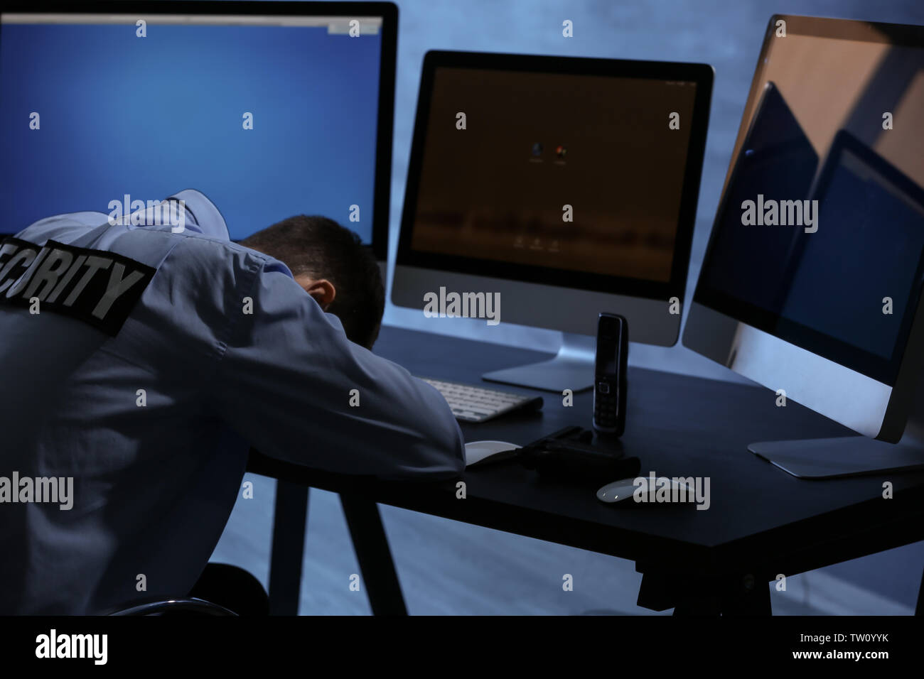 Male security guard sleeping at workplace Stock Photo - Alamy