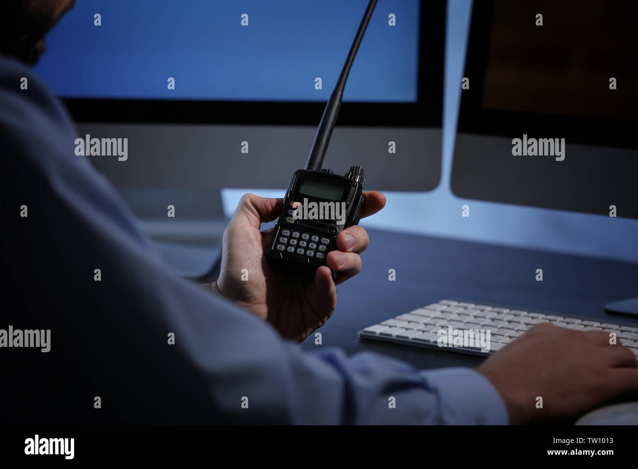 Hands of security guard on workplace Stock Photo - Alamy