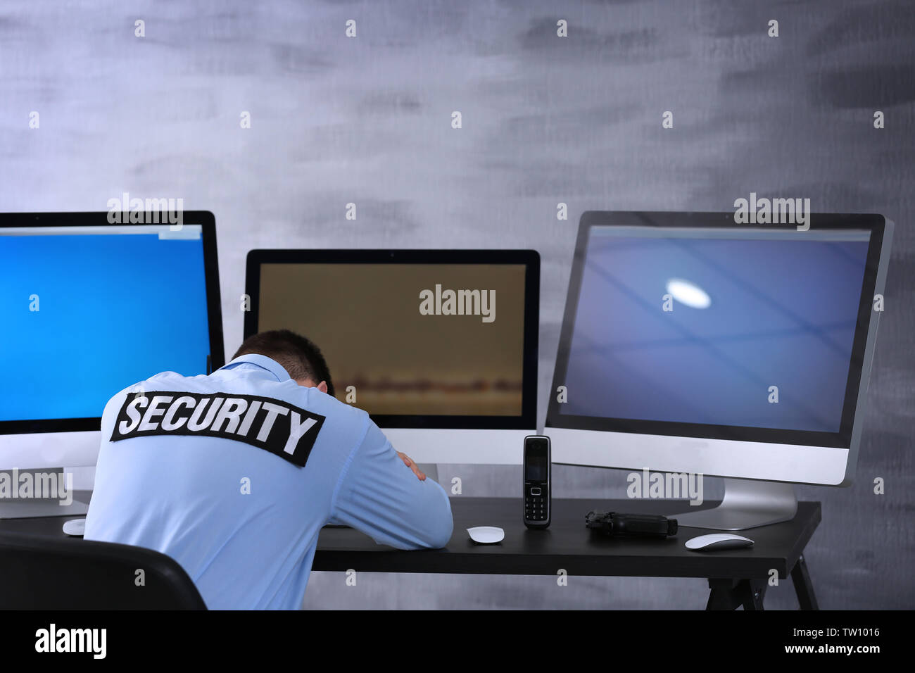 Male security guard sleeping at workplace Stock Photo - Alamy