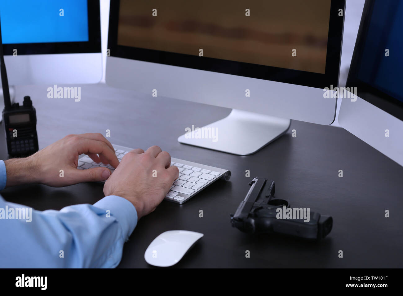Hands of security guard on workplace Stock Photo - Alamy