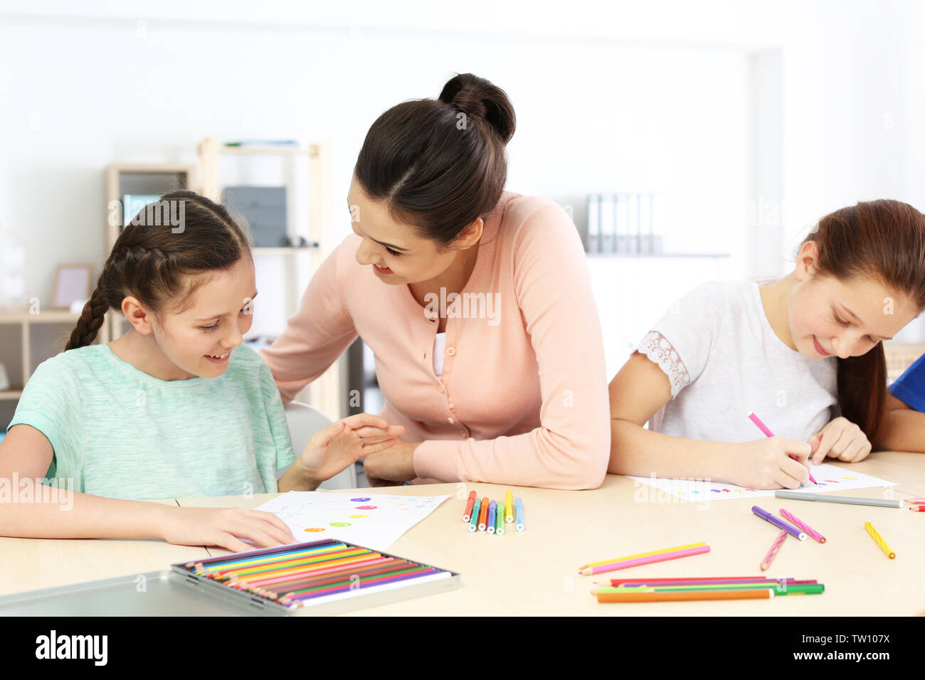 Female teacher conducting lesson in classroom Stock Photo - Alamy