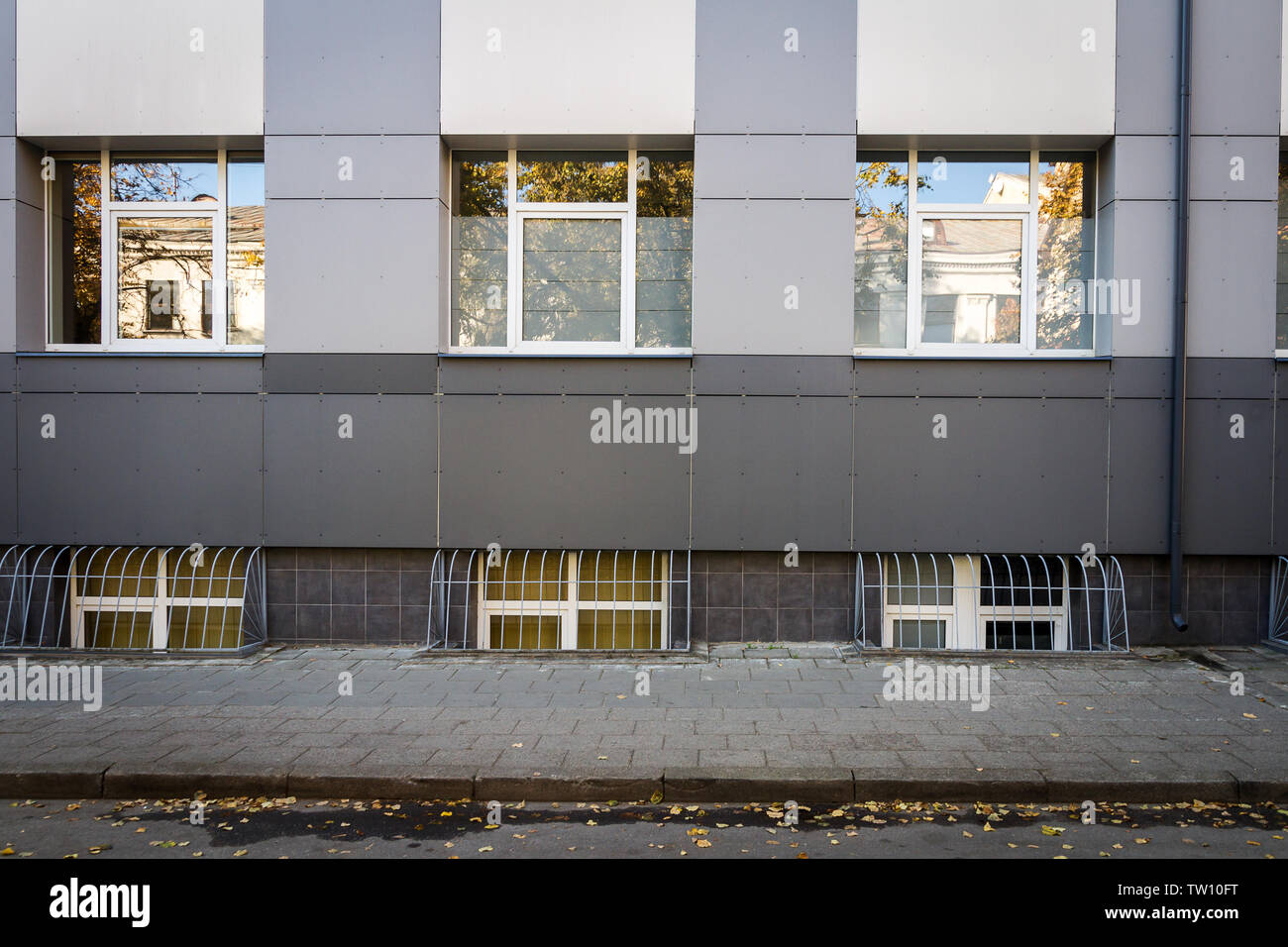 Modern silver and white color wall with some windows Stock Photo - Alamy
