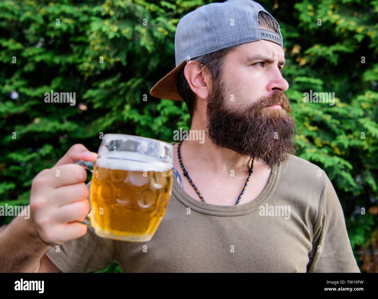 The most hipster drink ever. Hipster man with craft beer on summer day ...