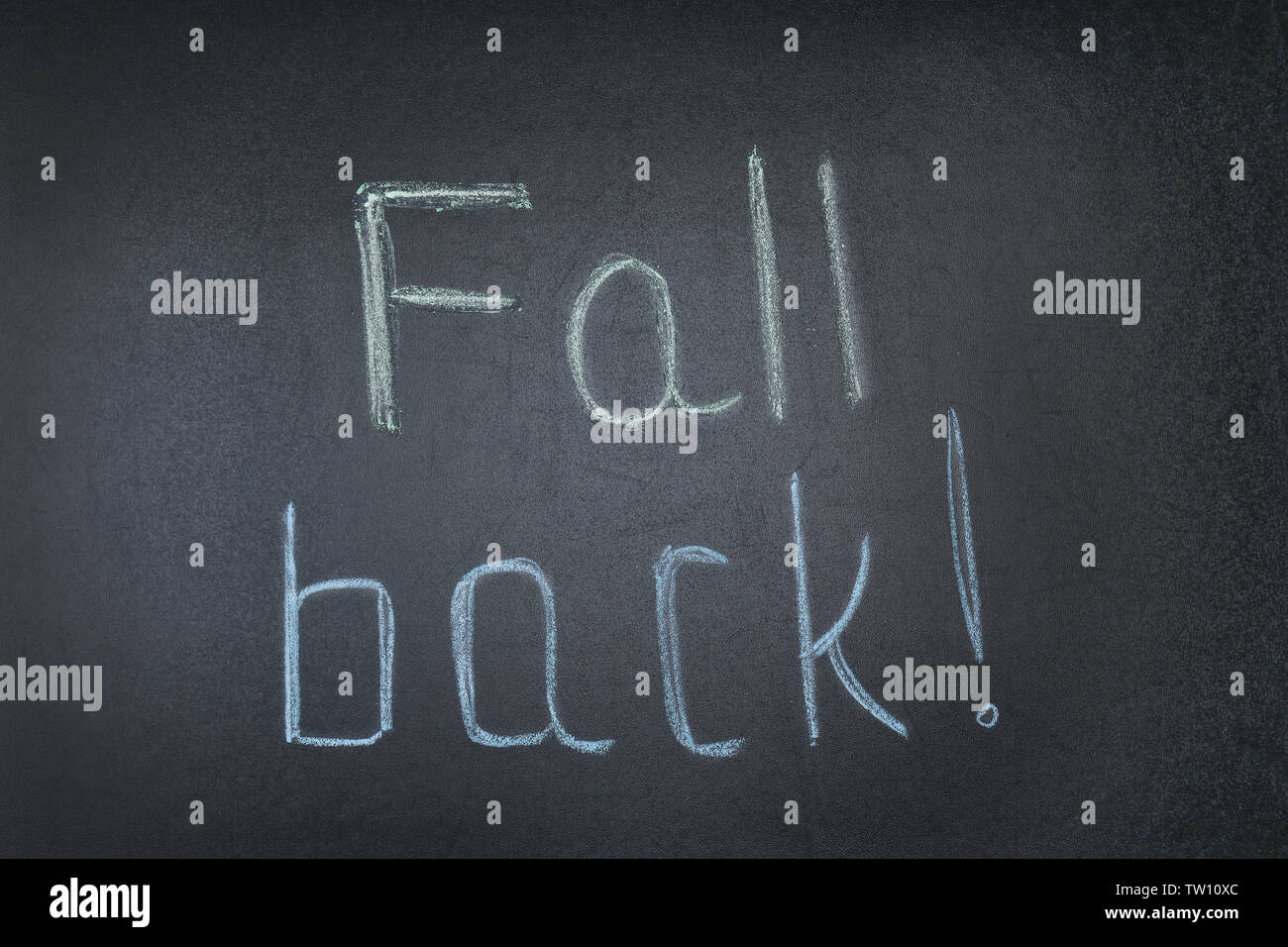 Phrase FALL BACK on blackboard Stock Photo - Alamy
