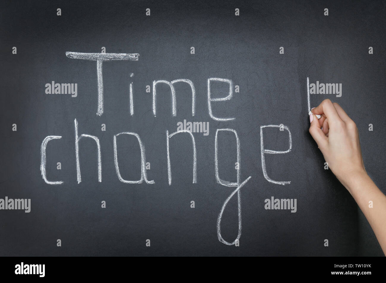 Female hand writing phrase TIME CHANGE on blackboard Stock Photo - Alamy