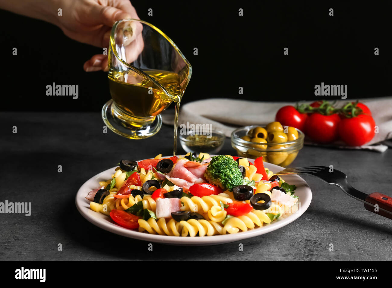 Female hand pouring oil hi-res stock photography and images - Alamy