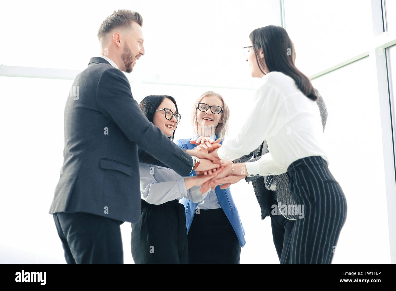 professional business team putting their hands together. the concept of ...