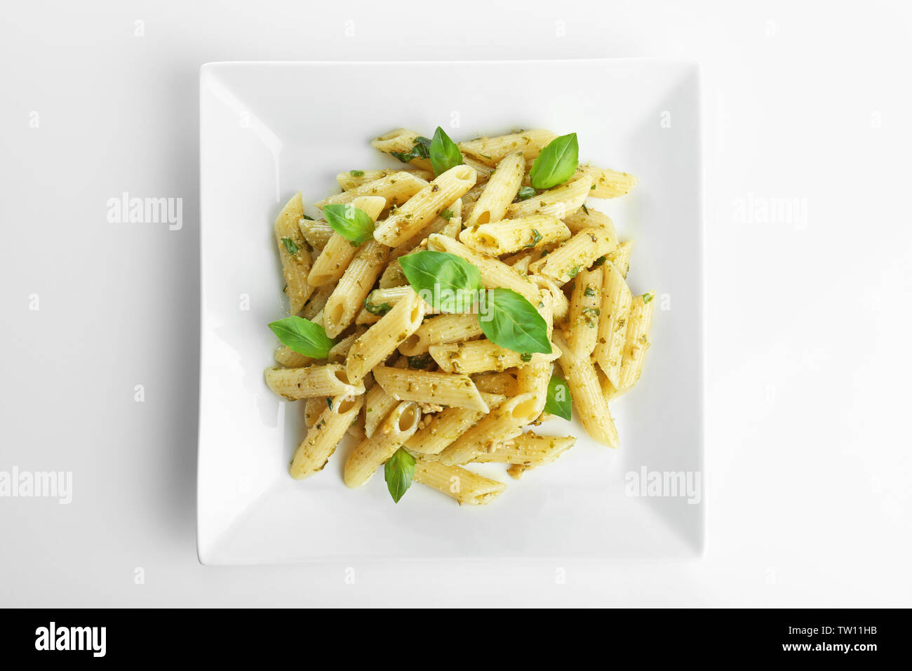 Plate with delicious pasta on white background Stock Photo - Alamy