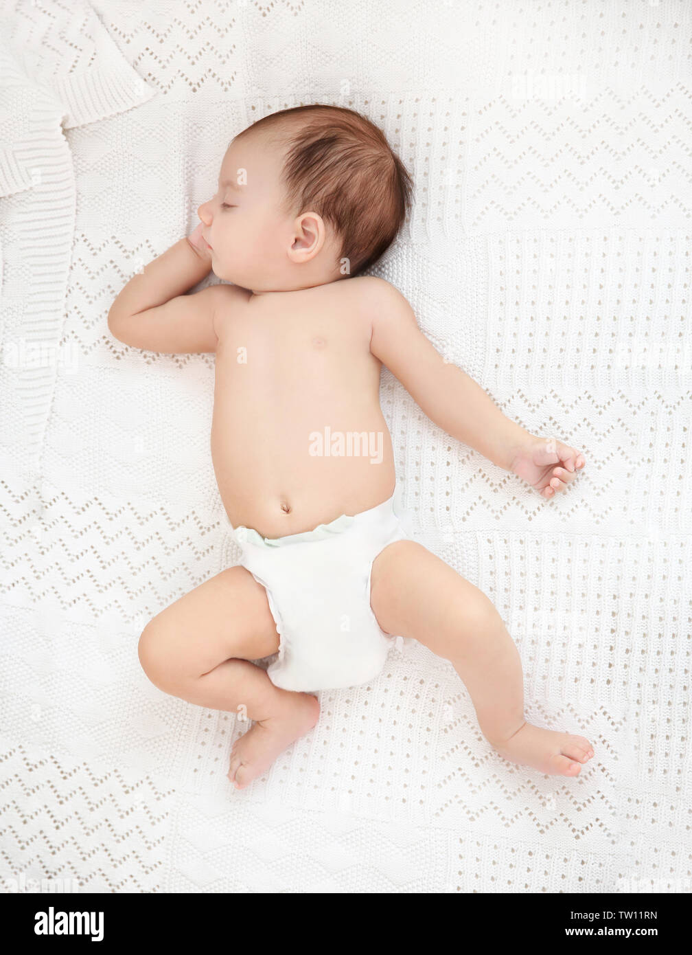 Cute little baby lying on soft plaid Stock Photo - Alamy