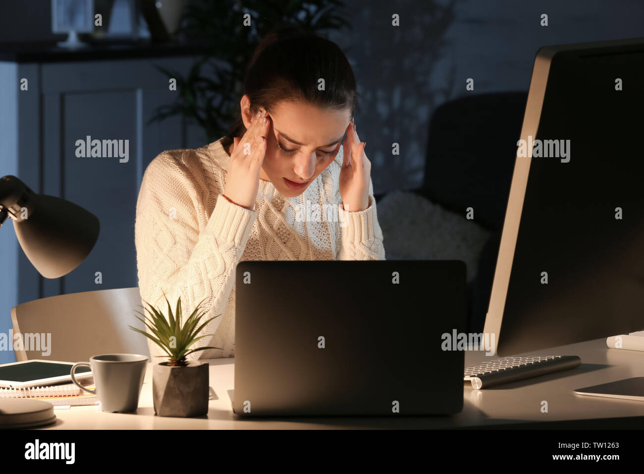 Tired woman working at night Stock Photo - Alamy