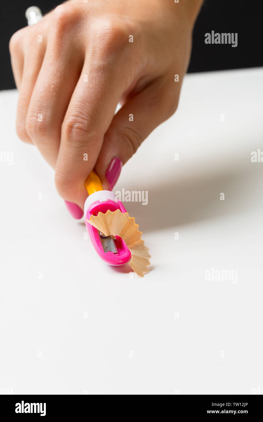 Woman is sharpening the pencil Stock Photo - Alamy