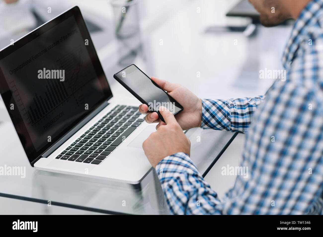 close up.business man looking at the screen of his smartphone. people ...