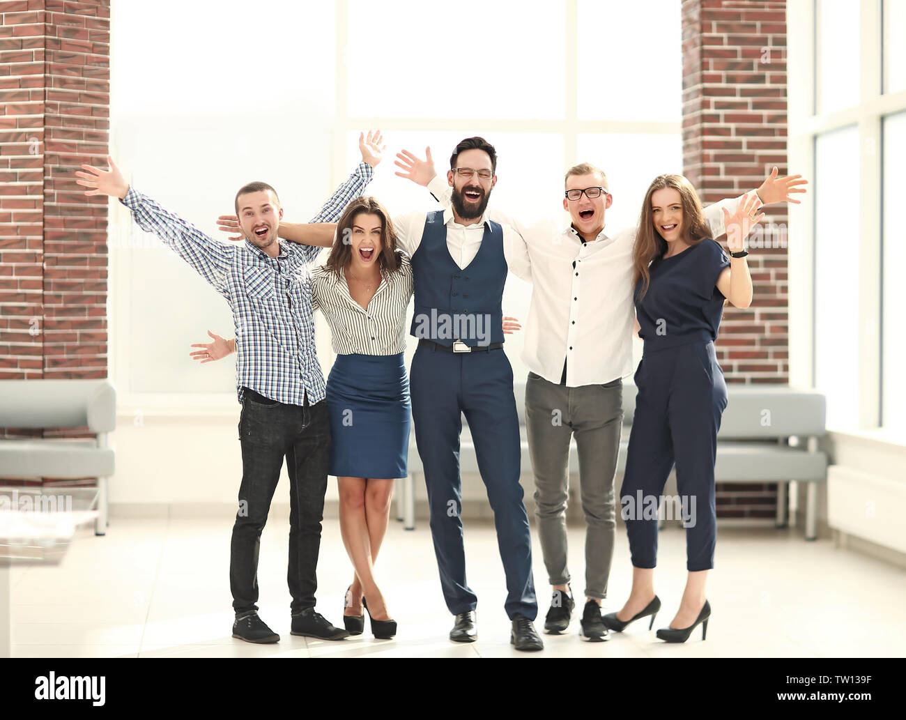 very happy business team standing in a bright office.photo with copy ...