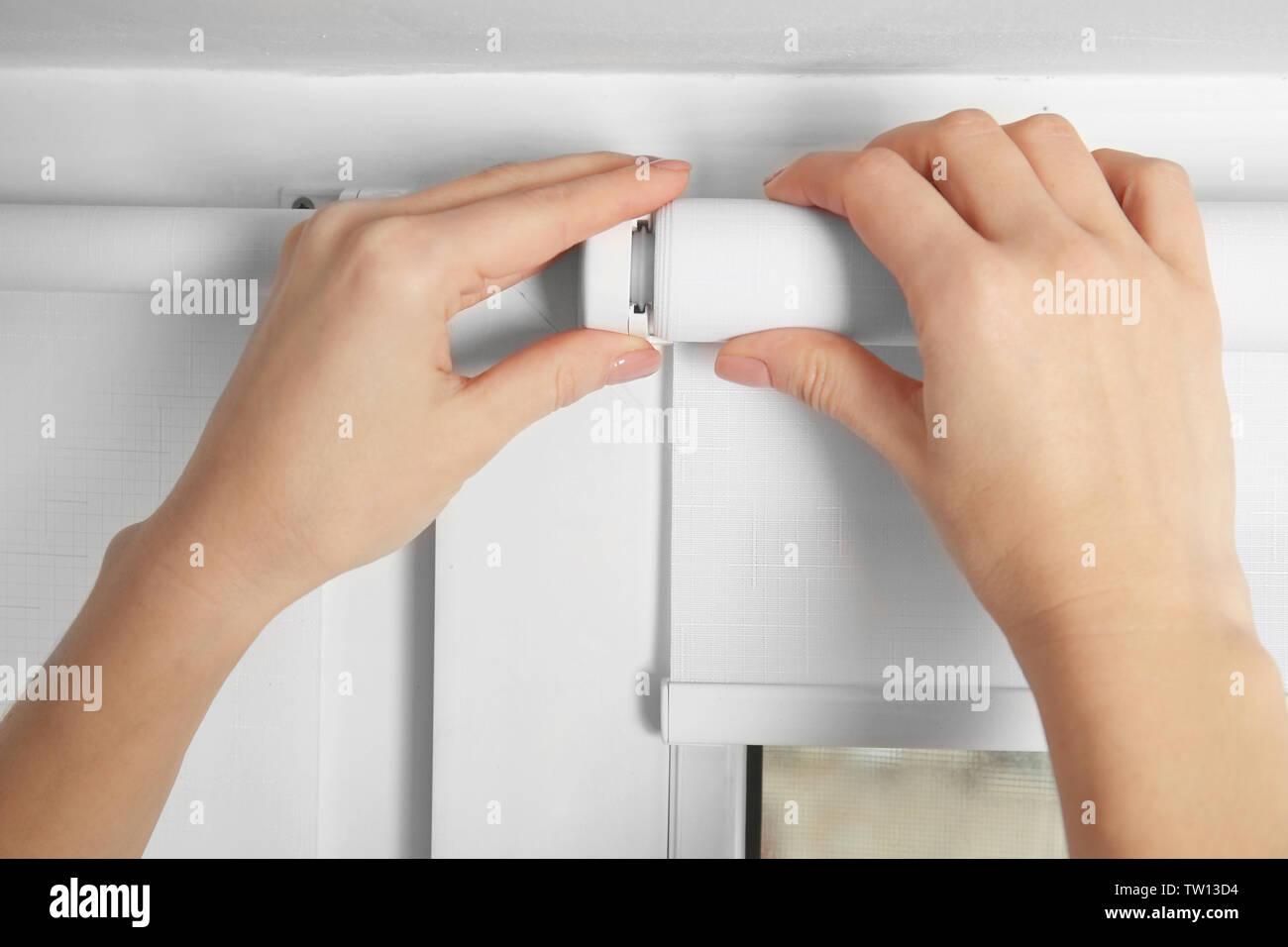 Woman hands installing window blinds, closeup Stock Photo - Alamy