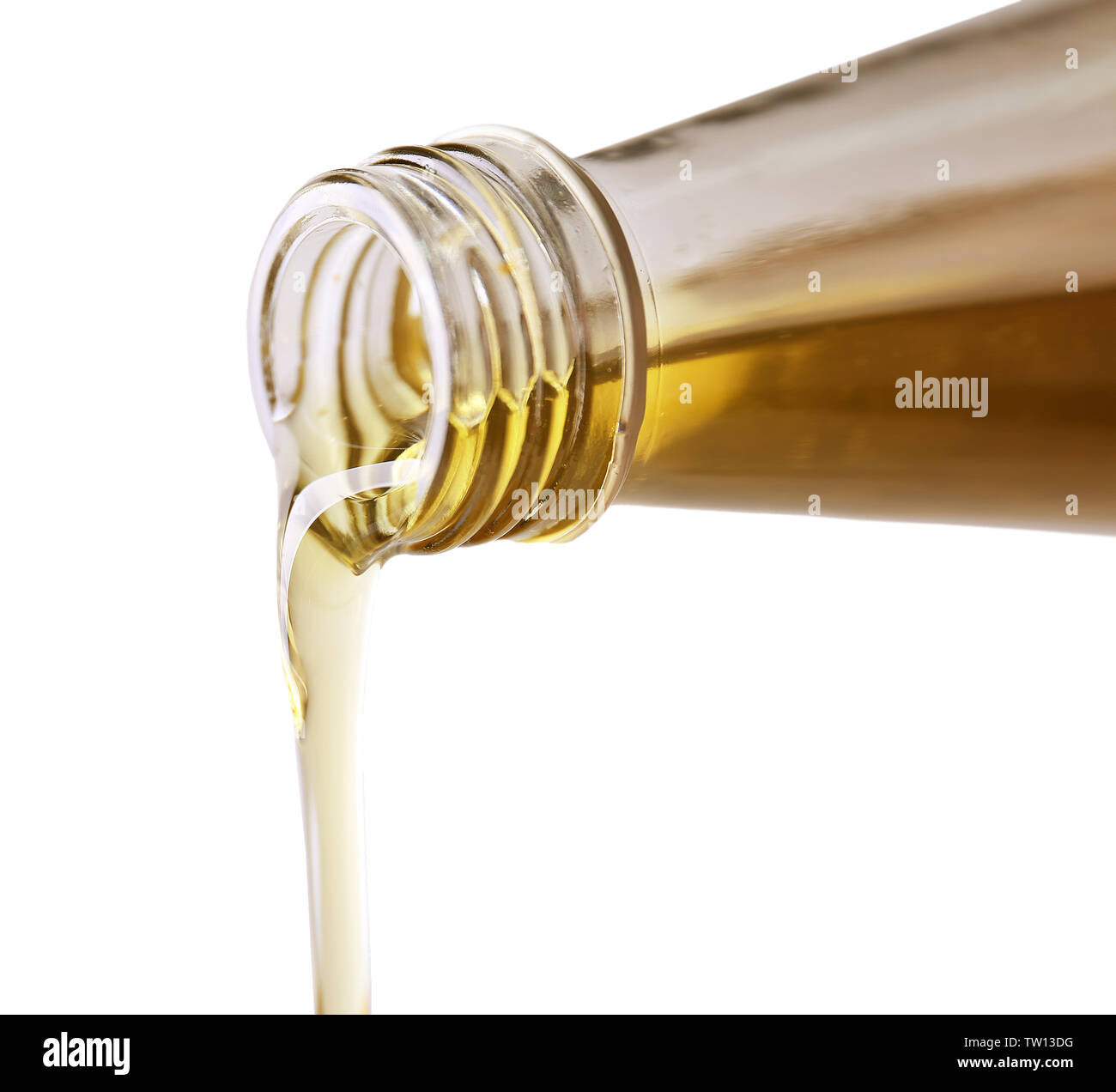 Pouring oil from bottle, isolated on white Stock Photo - Alamy