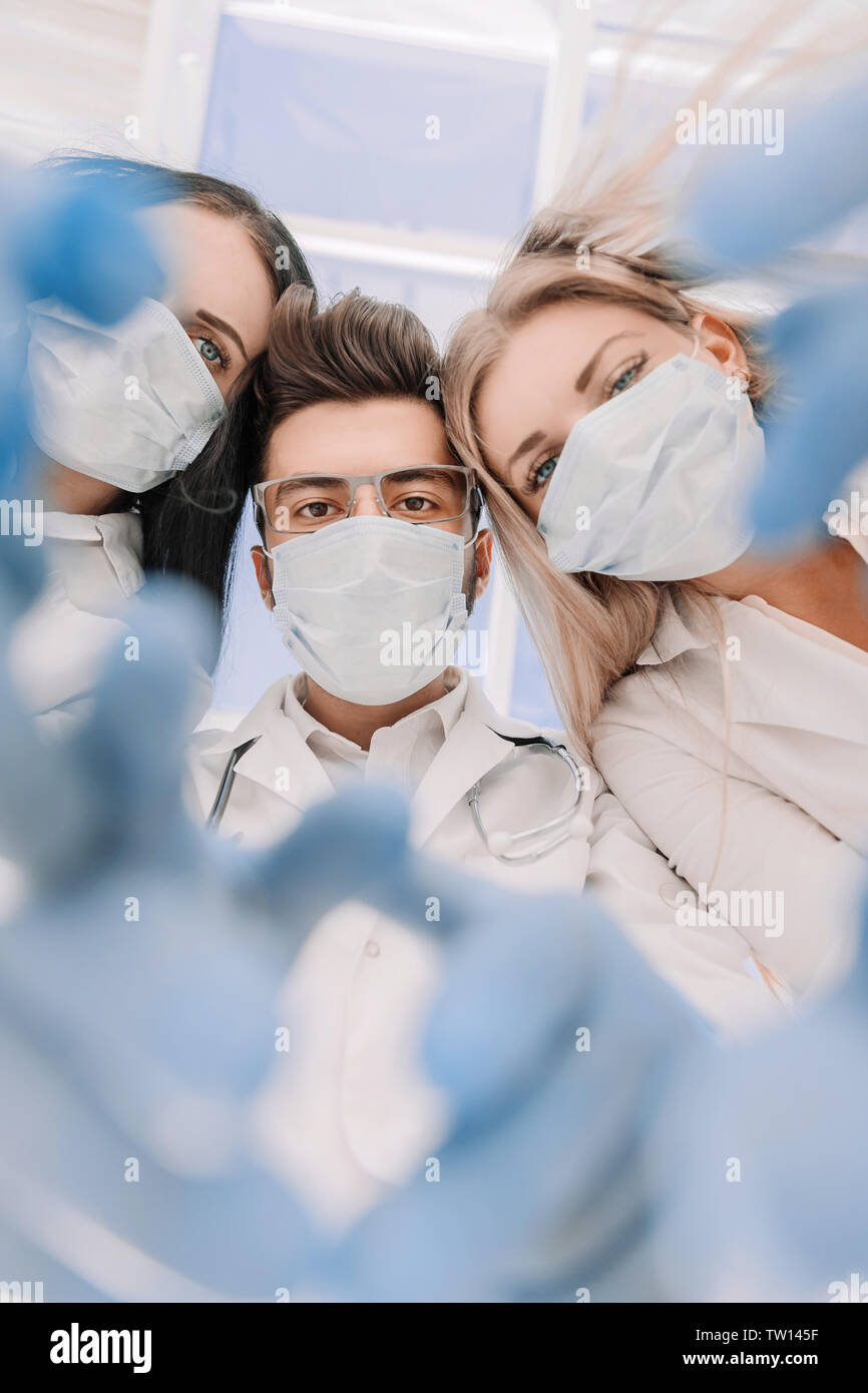Team surgeons are performing an operation using medical instruments, in ...