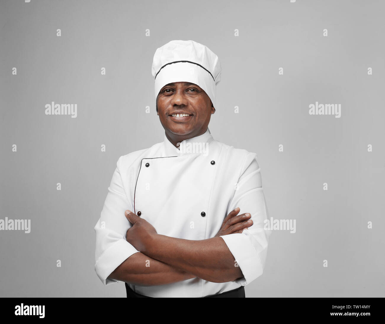 Indian chef in uniform on light background Stock Photo - Alamy