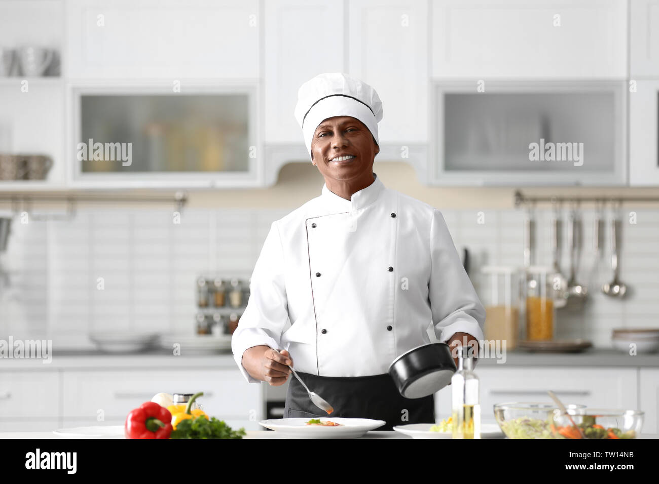 Mature Indian chef cooking in kitchen Stock Photo - Alamy